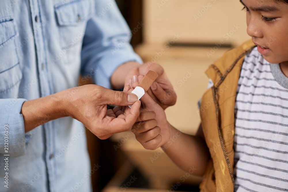Applying band-aid Stock Photo | Adobe Stock