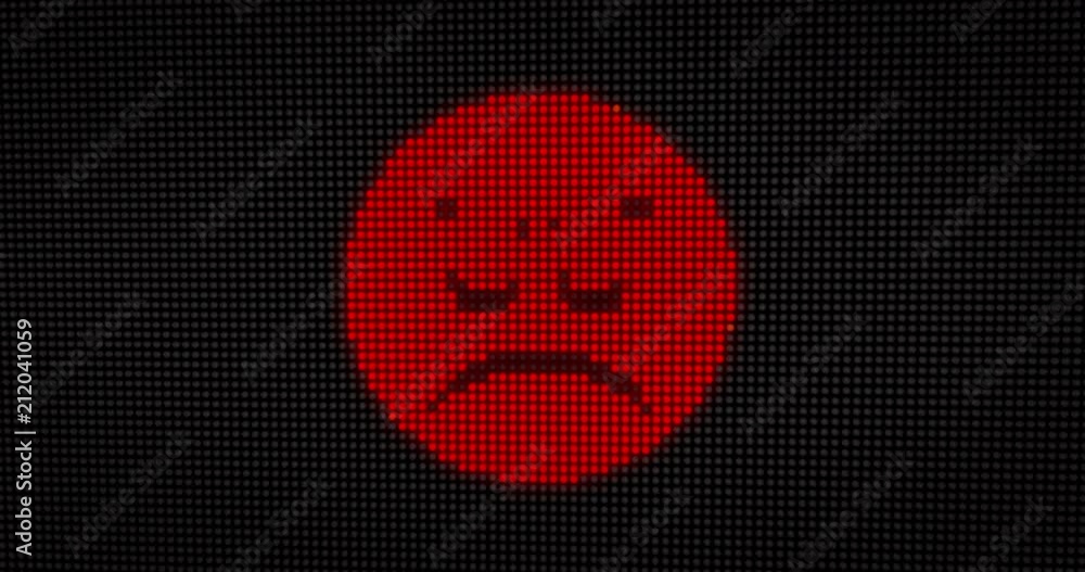 Emoticon angry face on big LED display with large pixels. Bright light ...