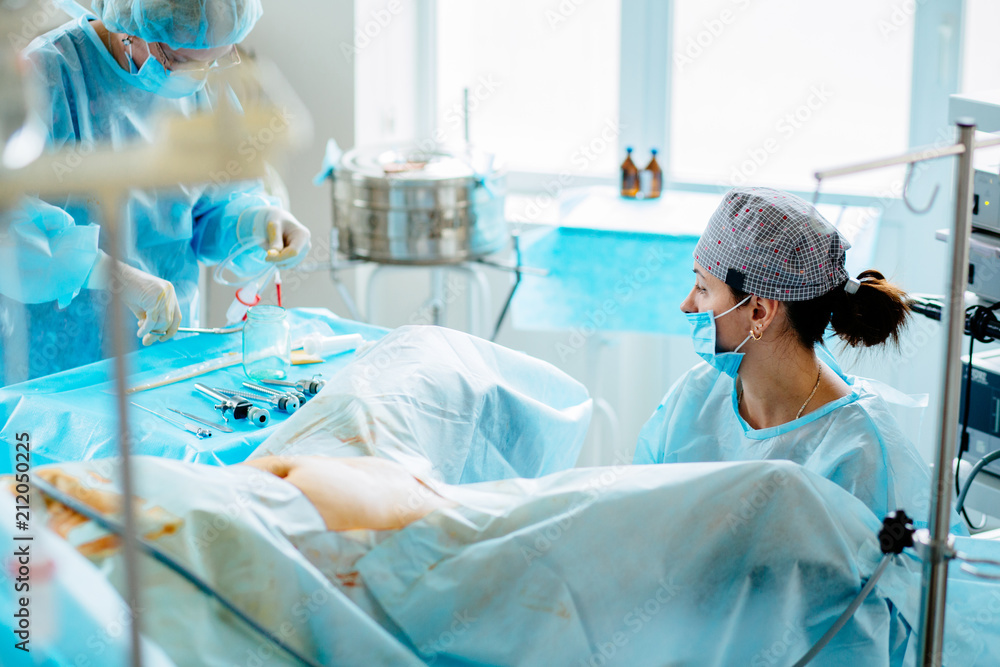 Female doctors performing gynecological operation at the hospital ...