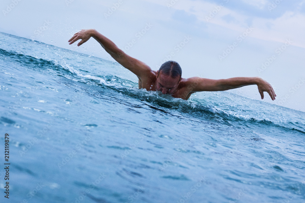 Tilted angle of a young man approaching with open arms on butterfly ...