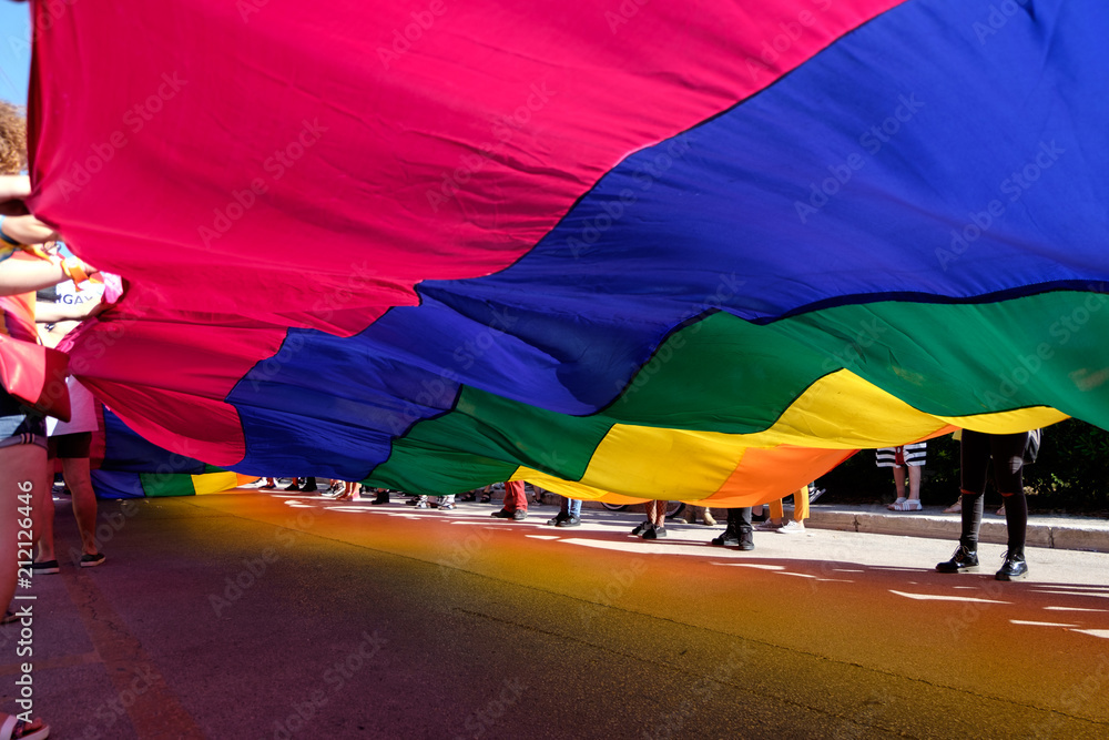 volunteers wawing a giant rainbow flag in a pride parade Stock Photo ...