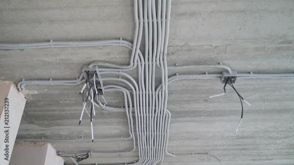 Electrical installation of plastic tubes on building site. Fix boxes ...
