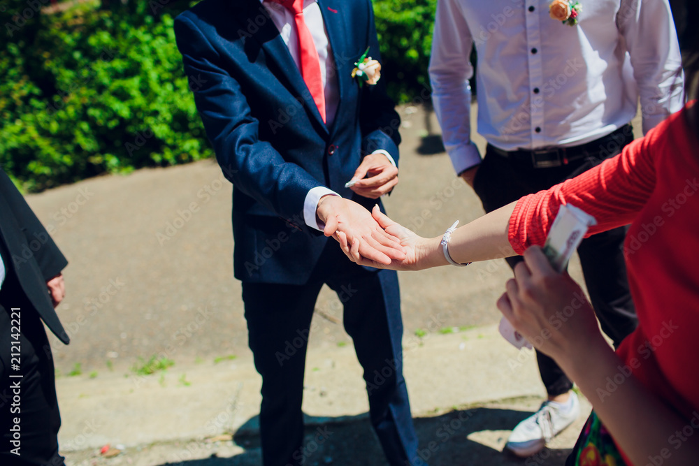 Hand injured bloody finger holds banknote grey background. Dirty money ...