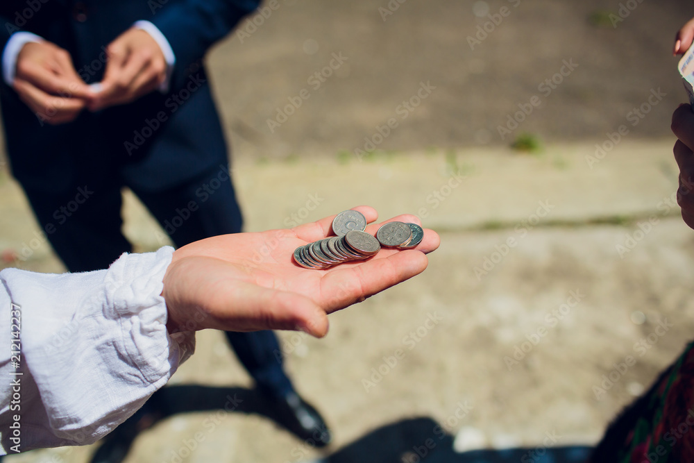 Hand injured bloody finger holds banknote grey background. Dirty money ...