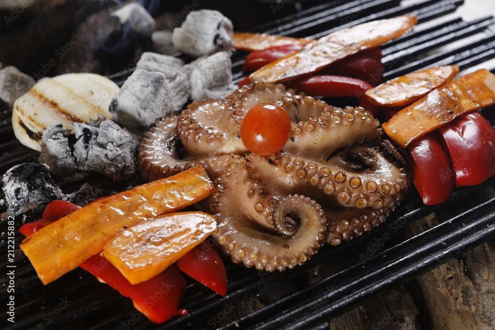 Grilled octopus served with carrot, pepper and onion. Octopus is a ...
