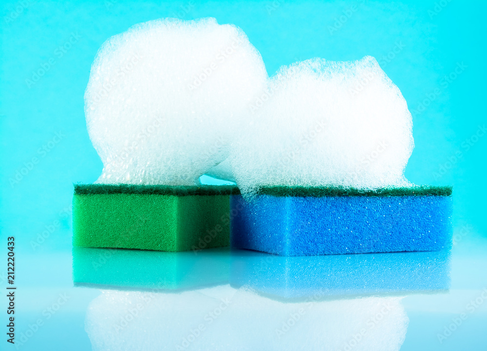 Sponge with foam and bubbles, close-up, texture, light blue background ...
