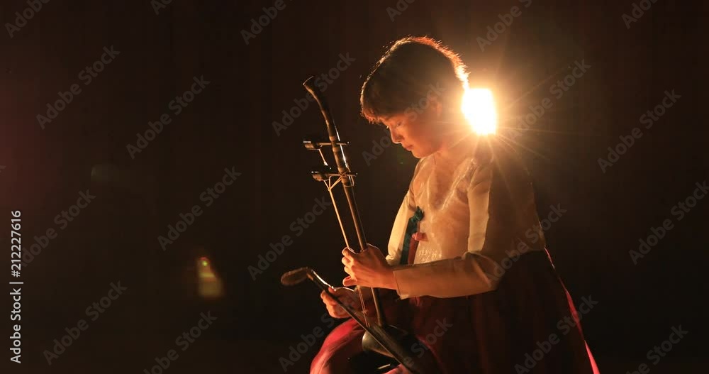Korean female musician playing the Haegeum which is the Korean ...