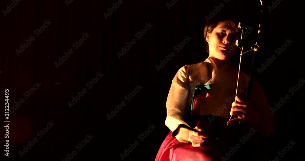 Korean female musician playing the Haegeum which is the Korean ...