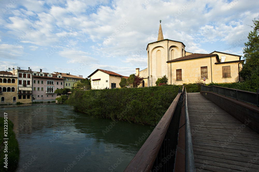 The bell tower and the cathedral of San Niccolò in Sacile on the river ...