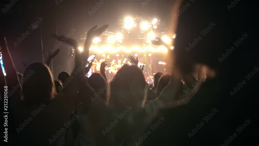 The crowd of shadows of people dancing at the concert, slow-motion ...