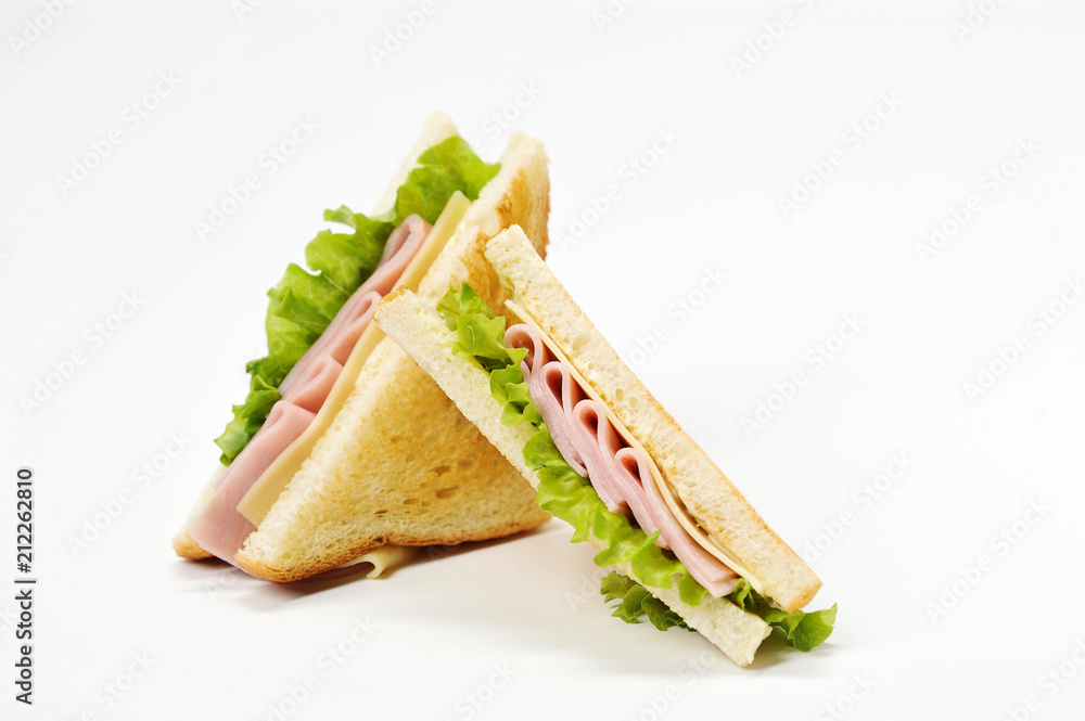 Two triangular sandwiches with cheese and ham. The sandwich is made ...