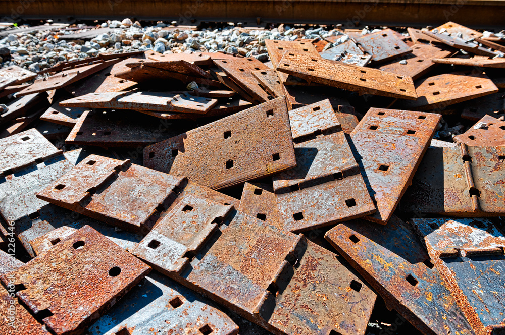 Pile of scrap rail railway railroad track rusty grungy metal plates ...