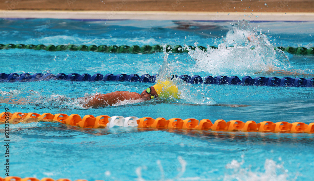 Swimmers swim free style, front crawl or forward crawl stroke in a ...