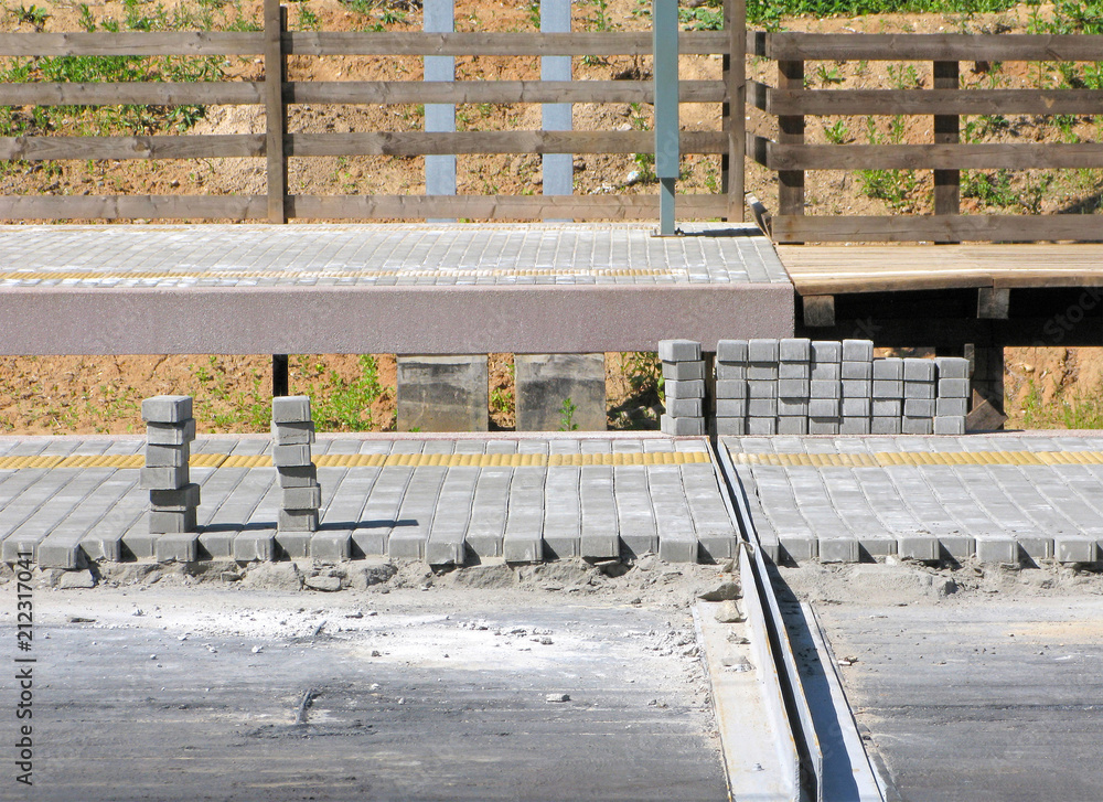 Rebuilding and construction of railway platforms. Laying of road tiles ...