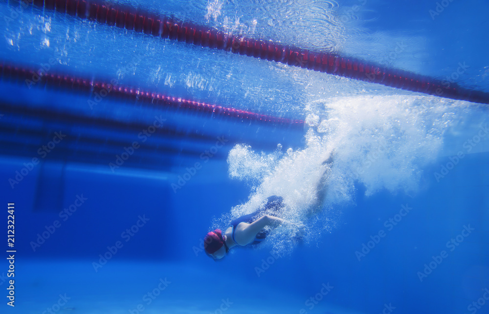 beautiful young girl with a good figure swims under water, effectively ...