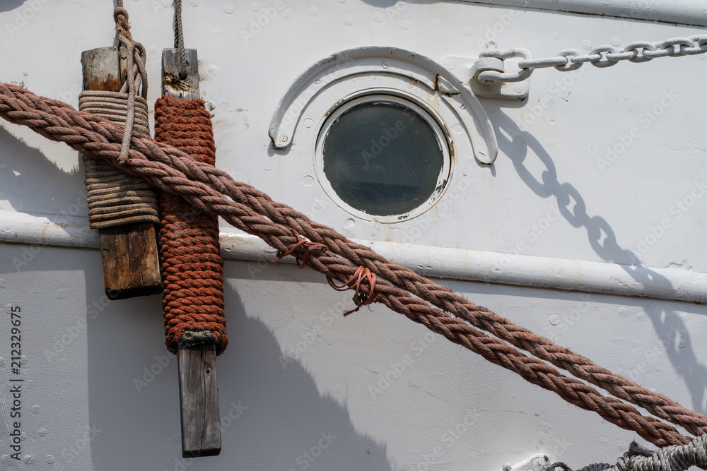 Ship mooring rope on the port wharf. Harbor bollard for large naval ...