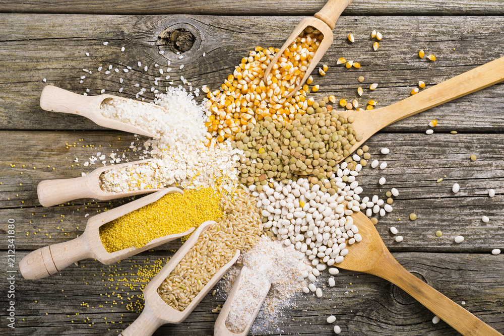 corn, millet, lentil, bean and other uncooked grain foods on old wood ...