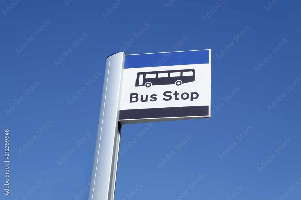 Bus stop sign sky background blue white clouds view below information ...