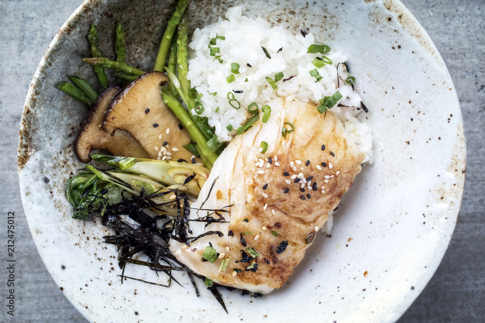 Modern Japanese fried cod fish filet with green asparagus and rice as ...