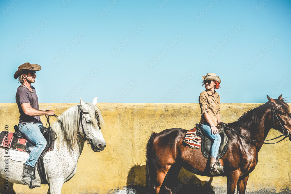 Couple riding horses in countryside tour - Happy people having fun on ...