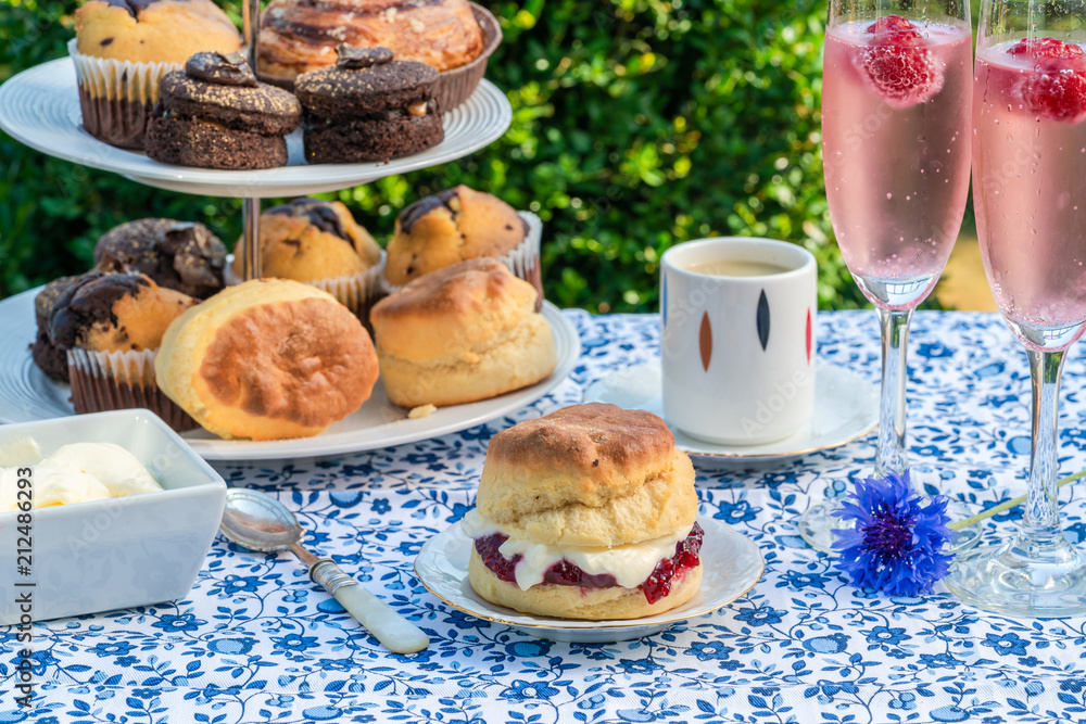 Afternoon tea with cakes and traditional English scones with strawberry ...