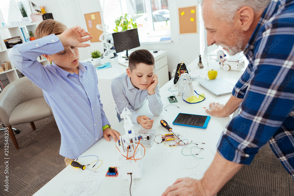 Science project. Nice smart boys working on their science project while ...