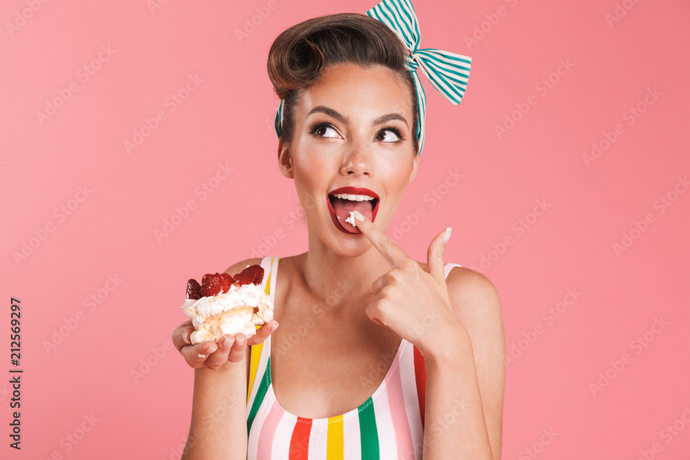 Beautiful pin up woman isolated holding cake. Stock Photo | Adobe Stock