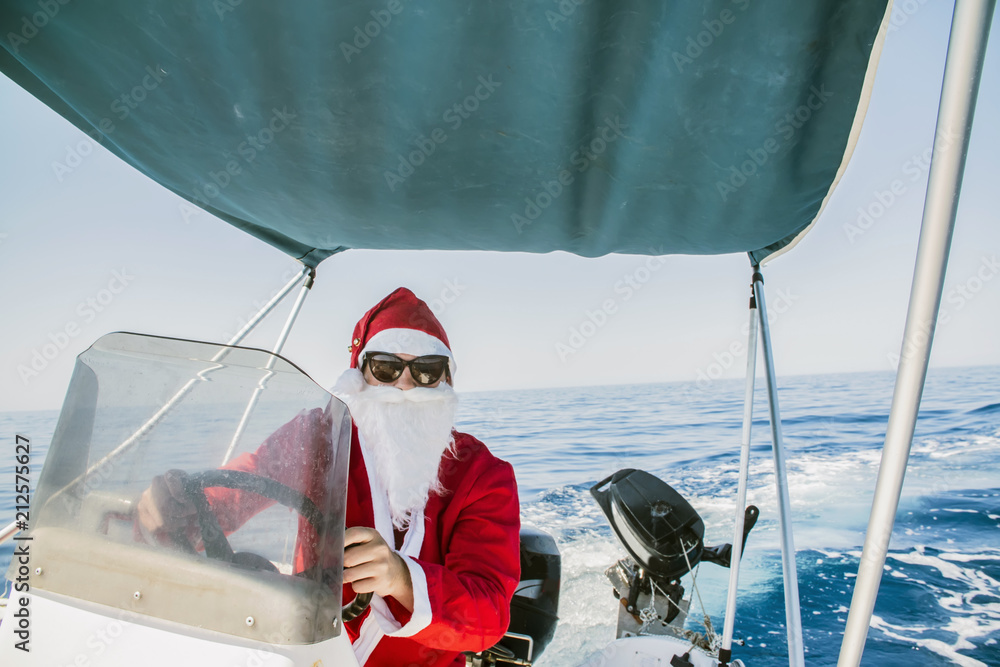 Santa Claus driving a boat on the sea Stock Photo | Adobe Stock