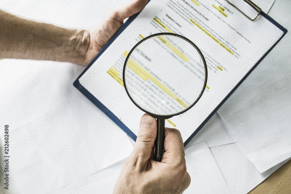 Legal team checking the fine print on business contract to analyze ...