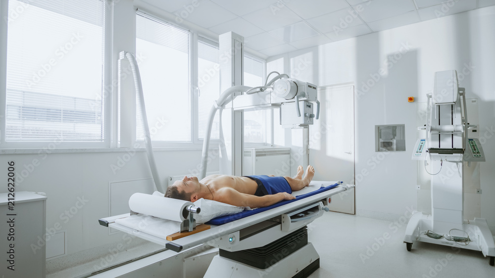 In the Hospital, Man Lying in Bed during X-Ray Machine Scanning ...