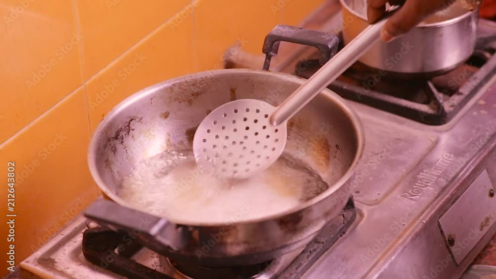 Deep frying puri ( poori ) Woman cooking recipe in indian kitchen Stock ...