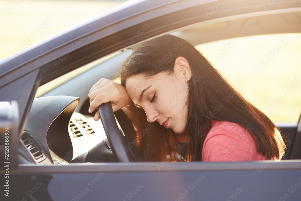 Transportation concept. Tired beautiful woman driver has sleepy ...