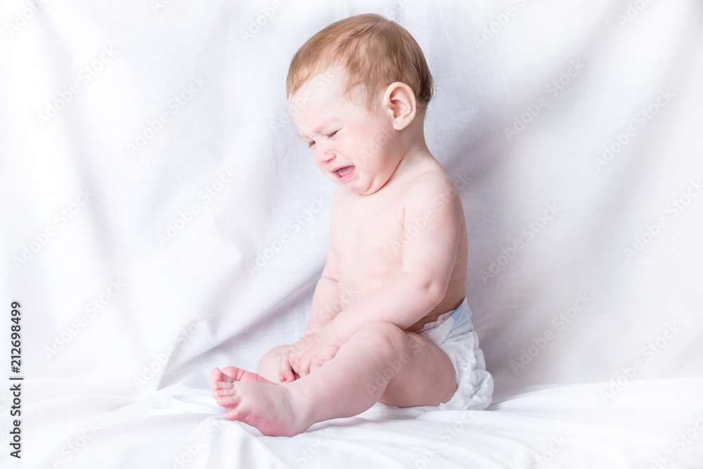Cute baby 6-9 months old sad crying white background. Children's ...