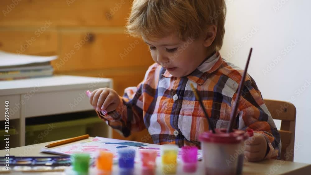 Cute little boy drawing in his album. Concept of early childhood ...