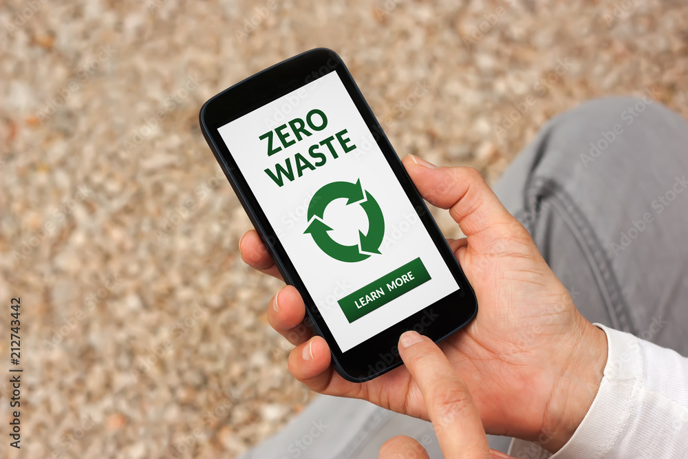 Hands holding smart phone with zero waste concept on screen. All screen ...