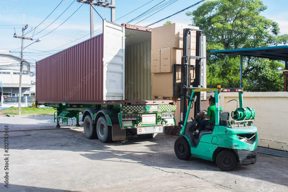 The worker loading pallet with a forklift into a truck. Stock Photo ...