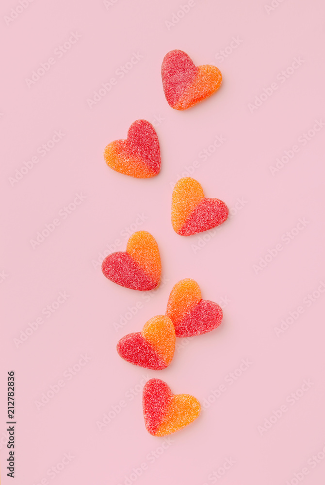 Heart shaped candy red and orange color on a pink background. Seven ...