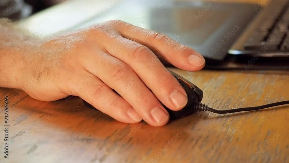 Close up view on human hand scrolling black mouse wheel. Man's hand on ...