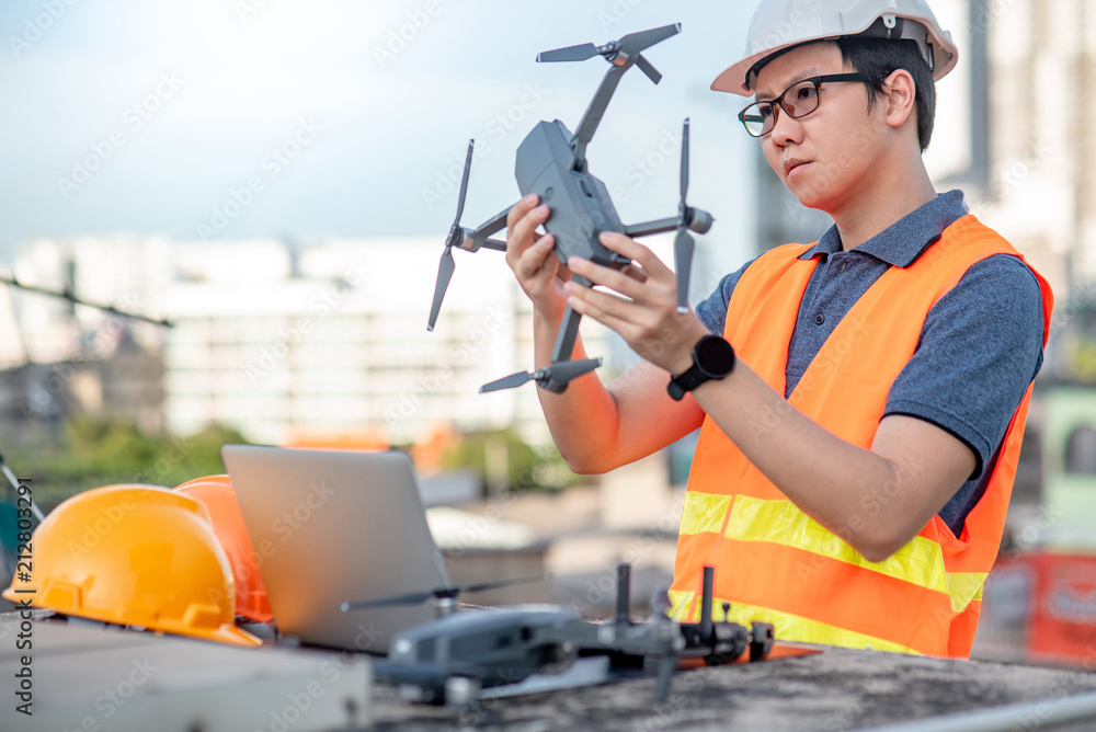 Young Asian man working with drone laptop and smartphone at ...