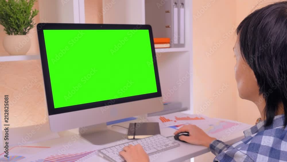businesswoman working on computer. workplace with white desk folders ...