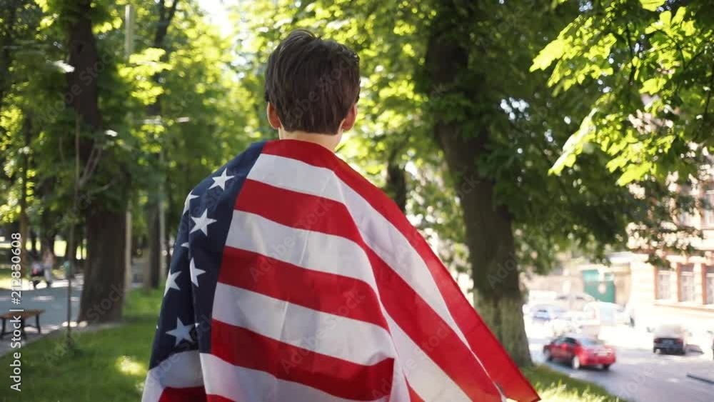 frame behind boy with American flag walk sunshine guy business fashion ...