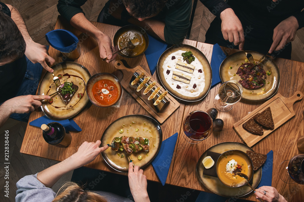 Friends dinner table top view. People eat healthy food together, home ...