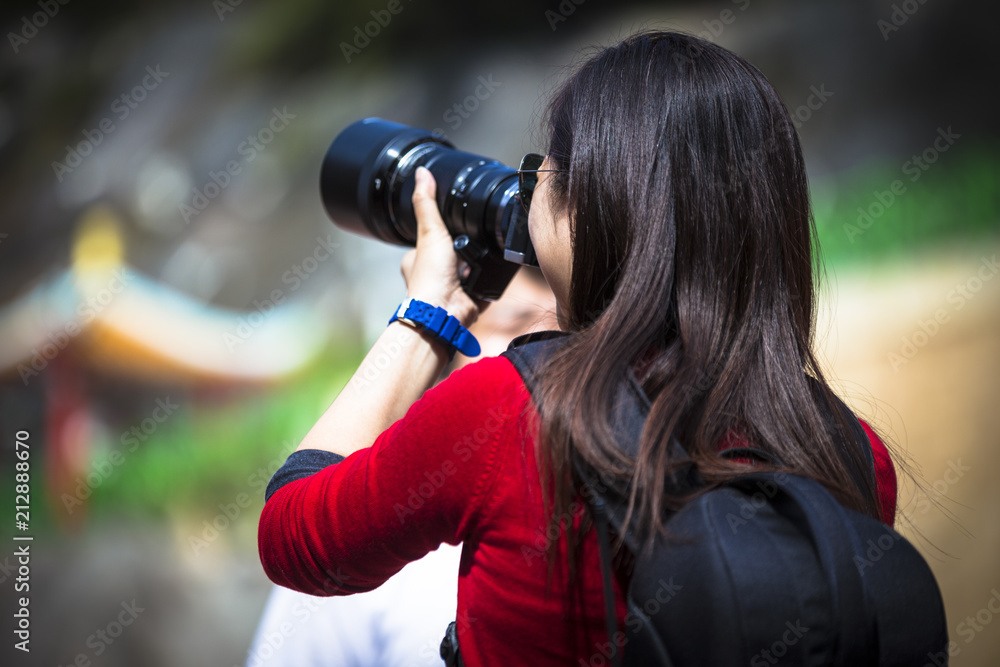 Young girl in midst of photography action with professional looking ...