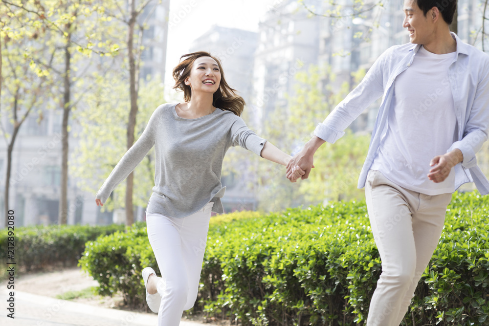 Couple Holding Hands Running