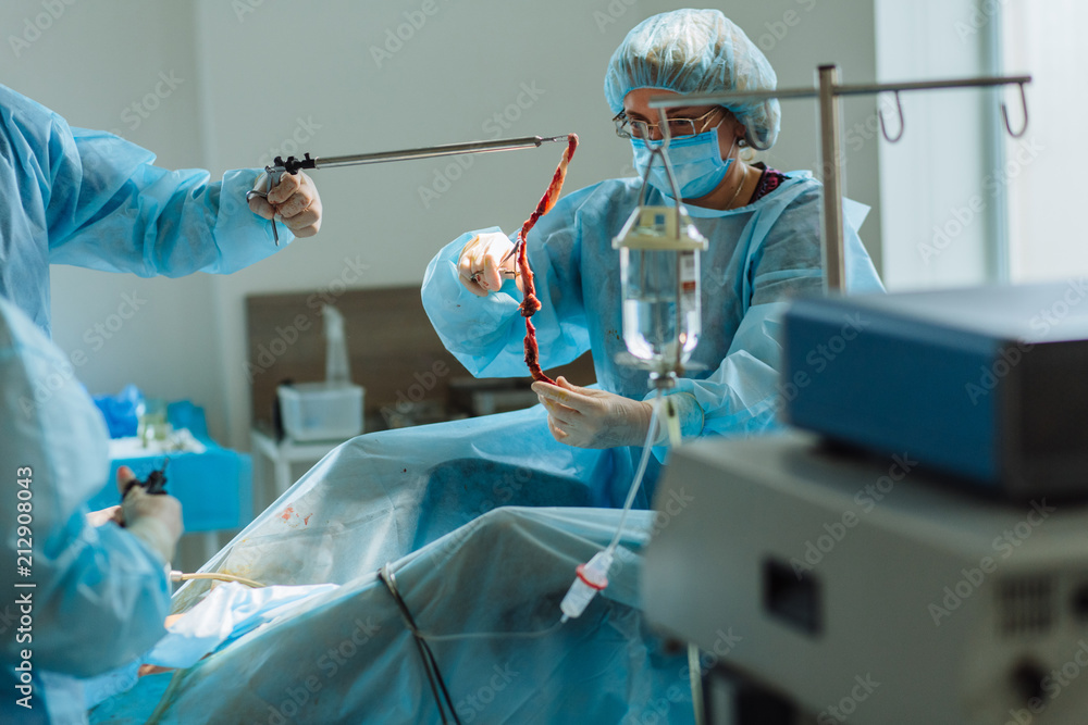 Surgeons team during process operation uterus removal with surgical ...