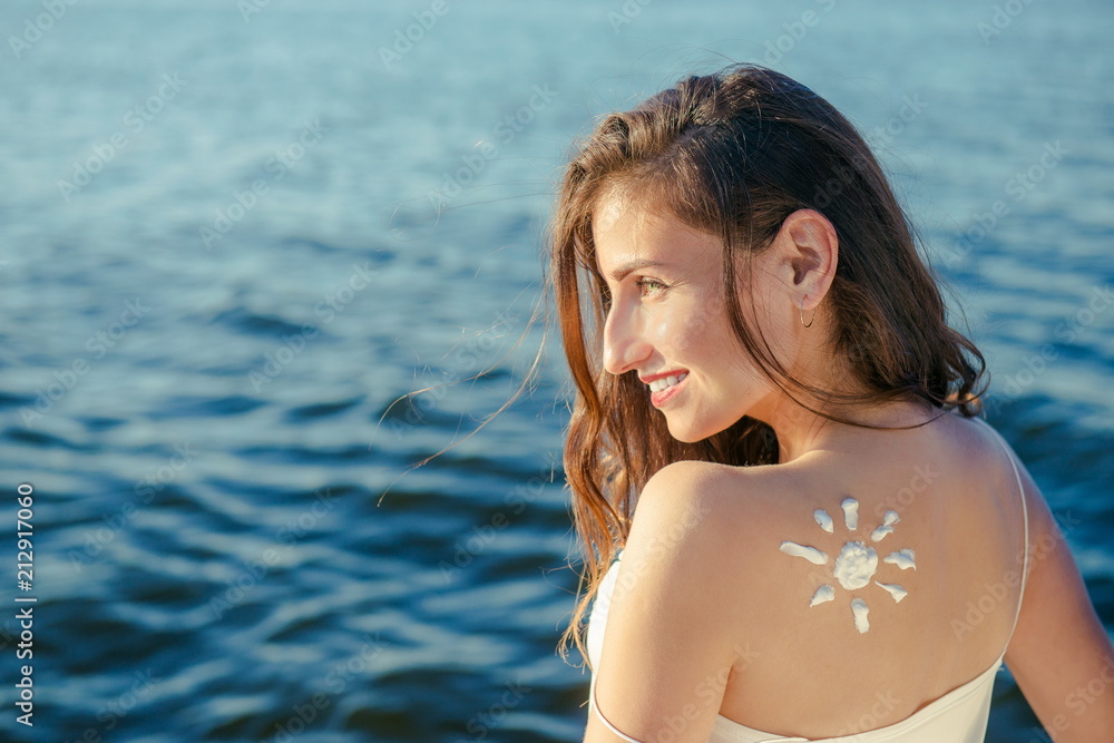 girl on the beach, woman on the sea. Sunbath protection. Woman using ...