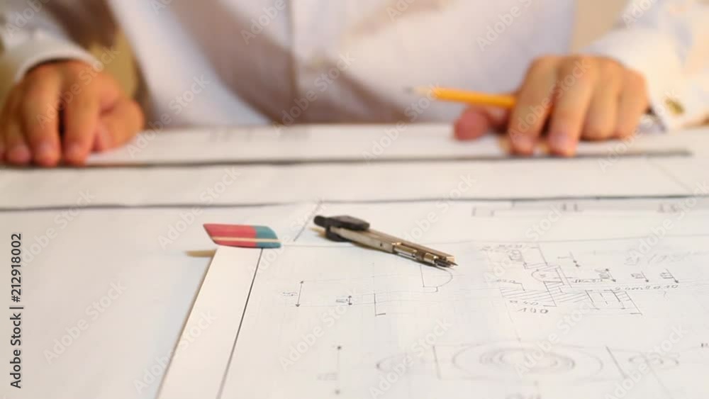 This stock video shows an engineer working in the office. He has a ...