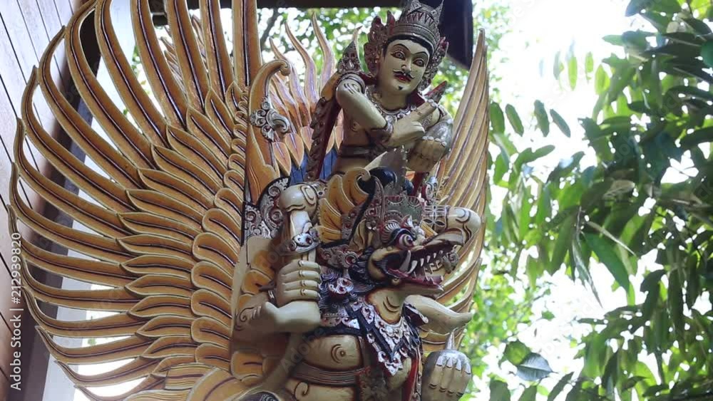 Balinese ancient colorful bird god Garuda with wings, close up ...