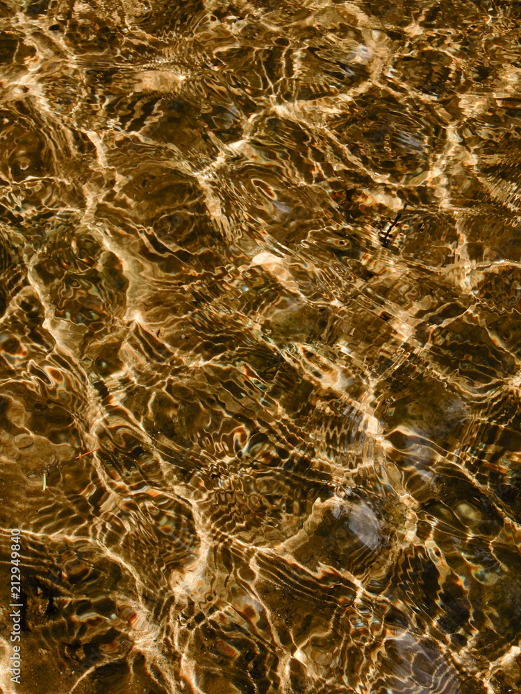 Caustic pattern produced by sunlight being refracted by the rippling ...
