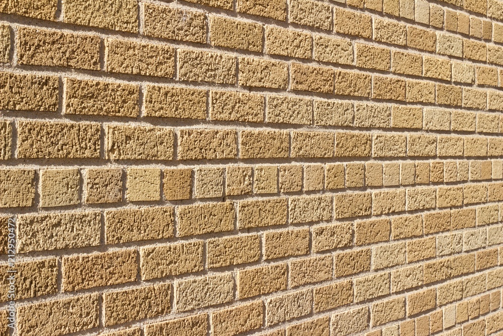 Vintage golden brown color brick wall (angle view) background in ...